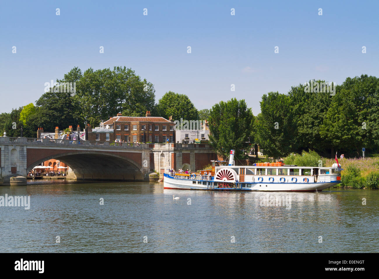 Boat passes Hampton Court on the River Thames in London England Stock ...