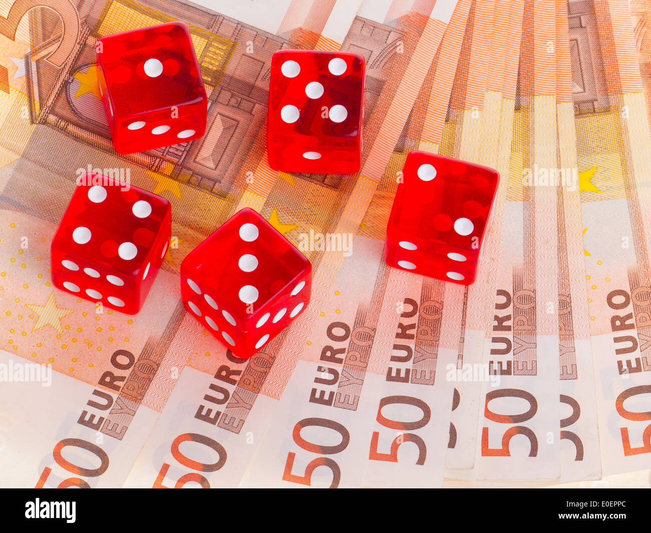 Red dice on top of some 50 euro banknotes Stock Photo - Alamy