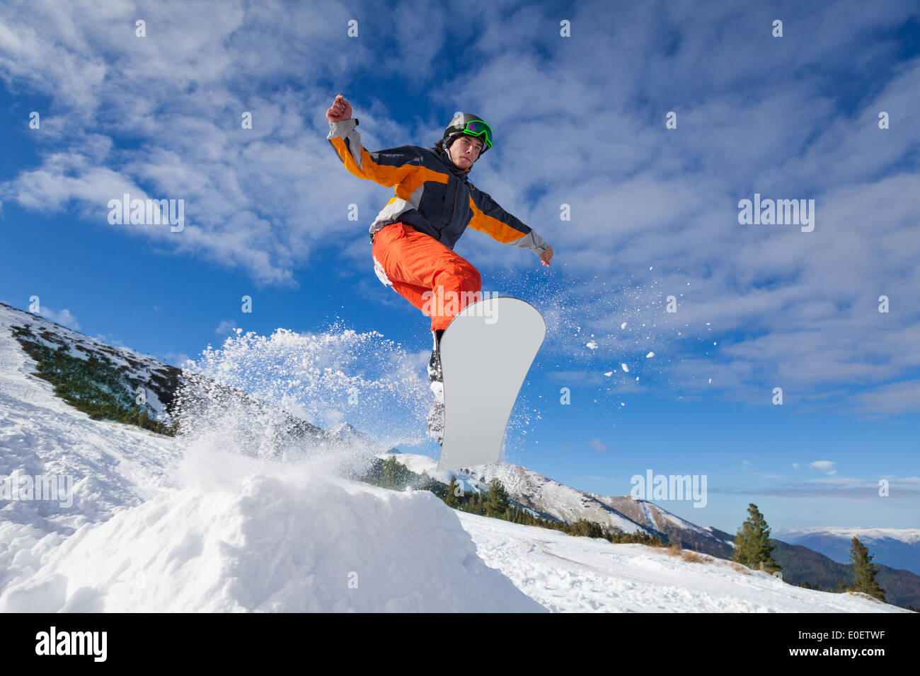 Man jumping with snowboard from mountain hill Stock Photo - Alamy