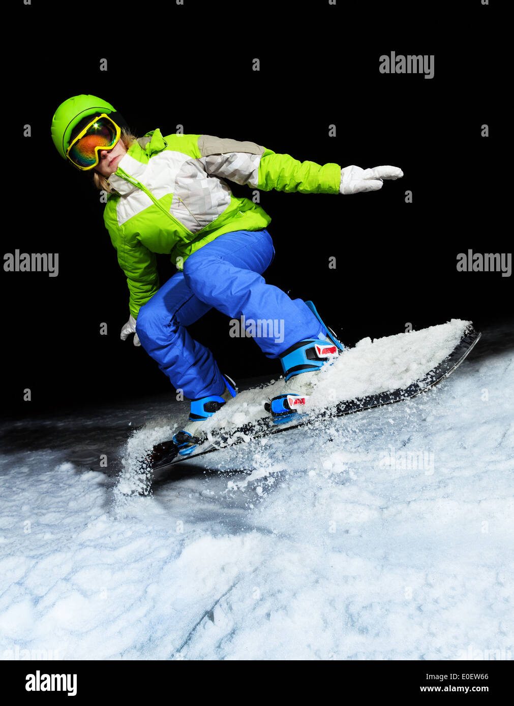 Portrait of girl jumping on snowboard at night Stock Photo - Alamy