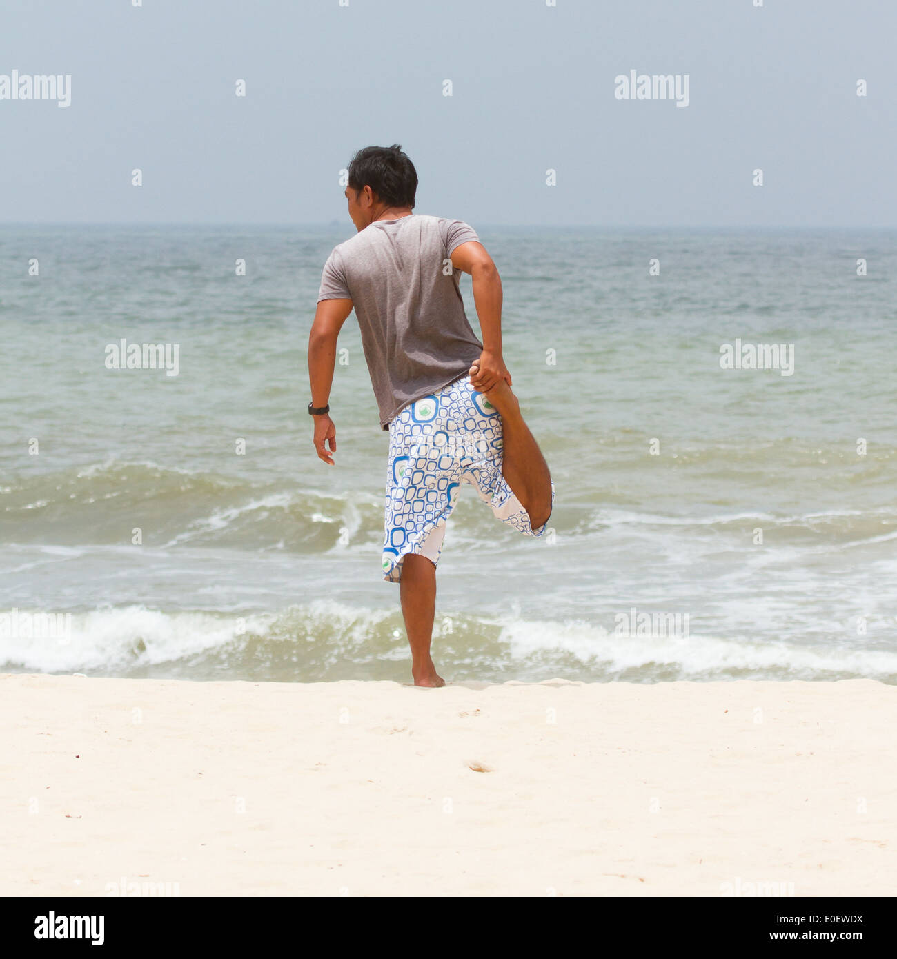 Man stretching on the beach at the south chinese sea (Vietnam Stock ...