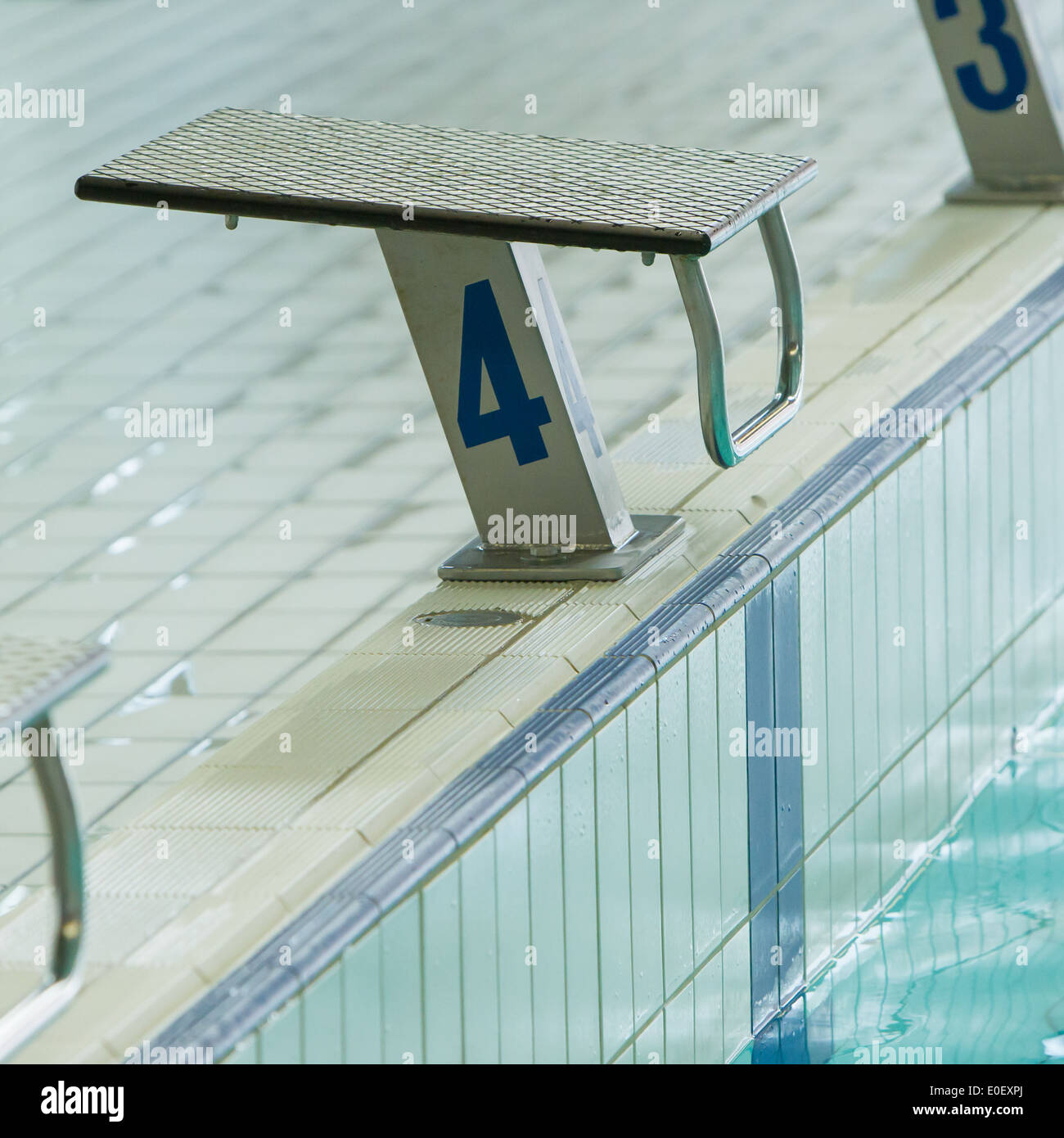 Swim race starting block and indoor pool, number 5 Stock Photo - Alamy