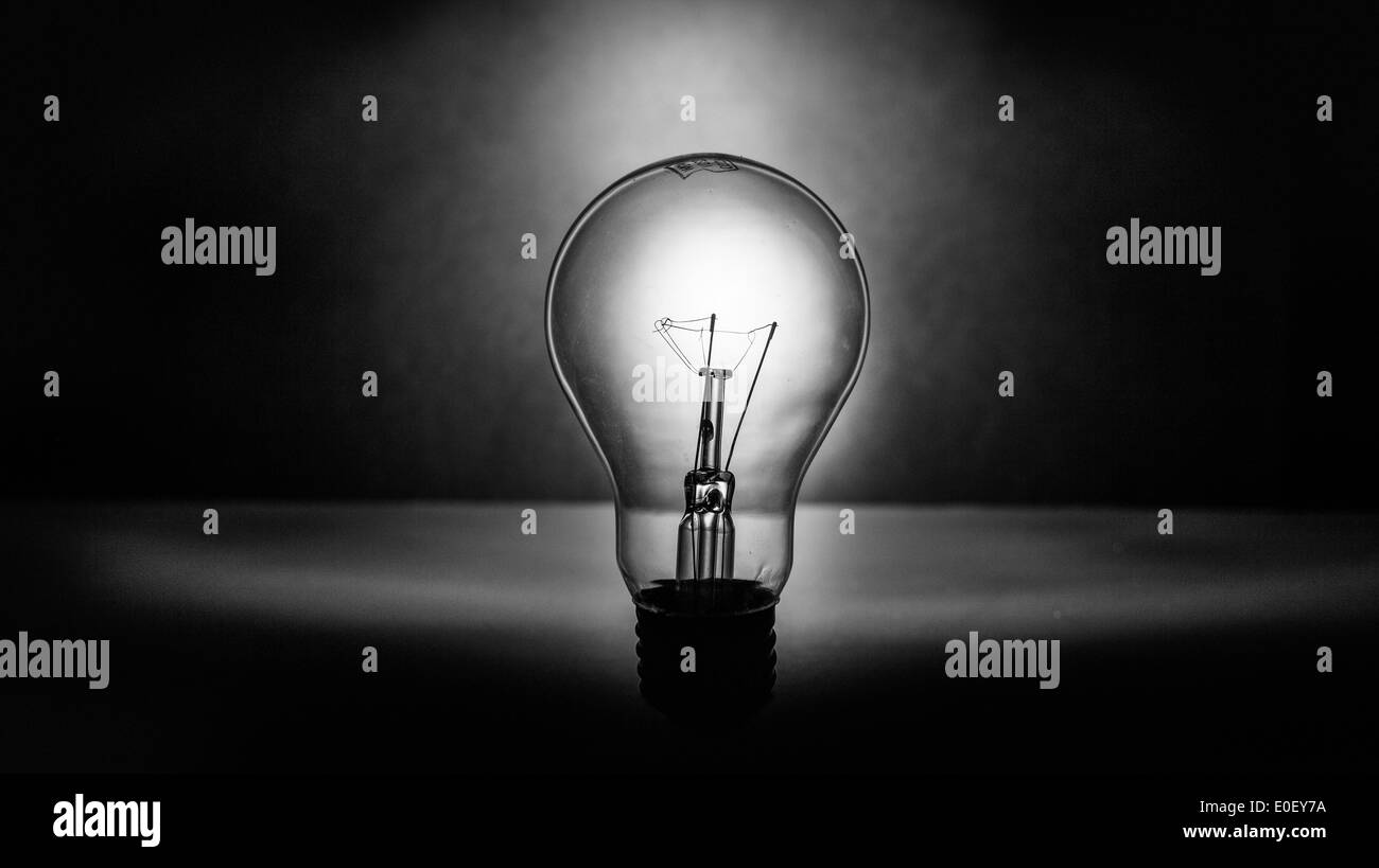 Light bulb against dark background Stock Photo - Alamy