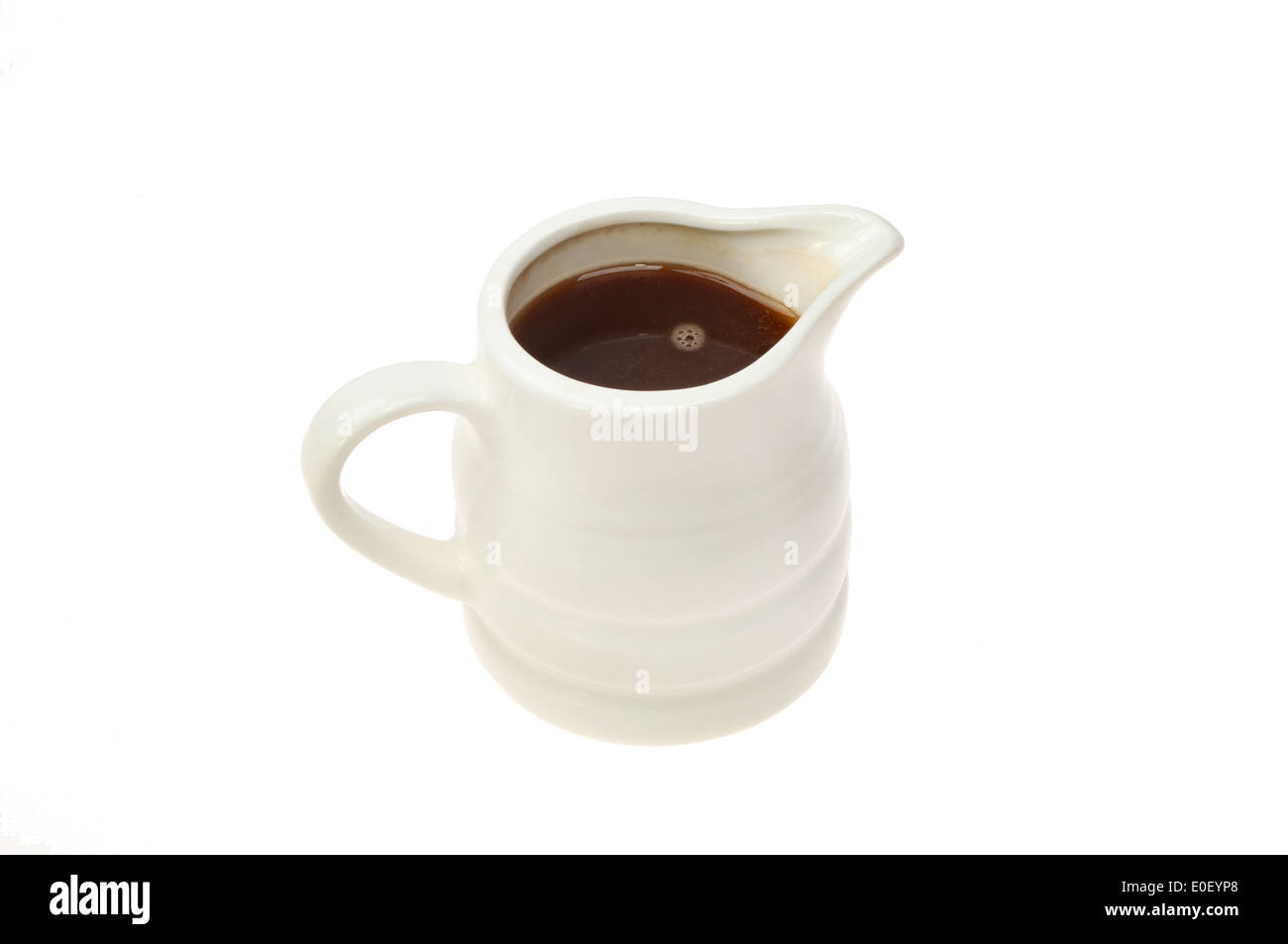 Gravy in a white china jug isolated against white Stock Photo - Alamy