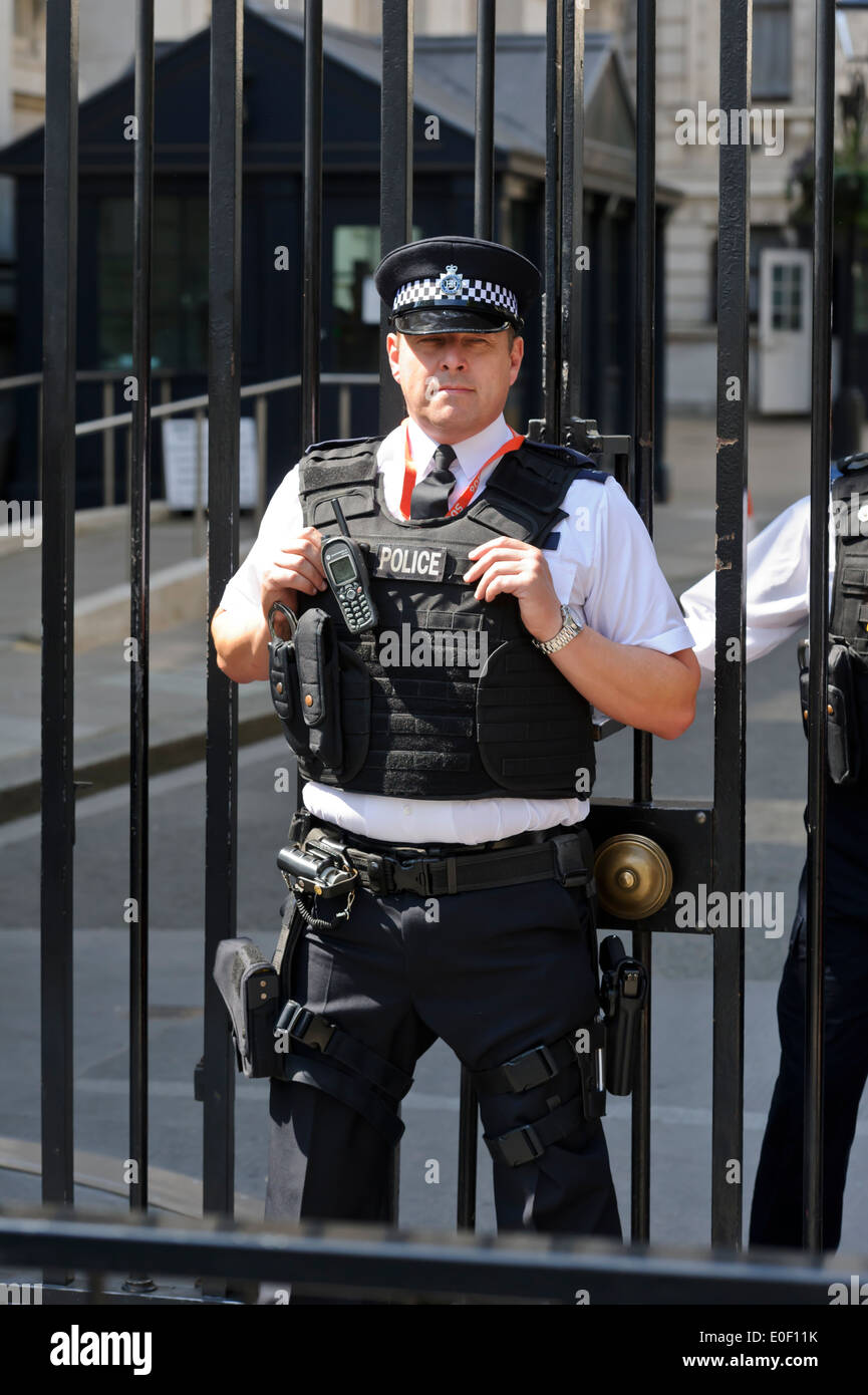 A Police officer on guard duty outside the gates of Downing Street, the ...
