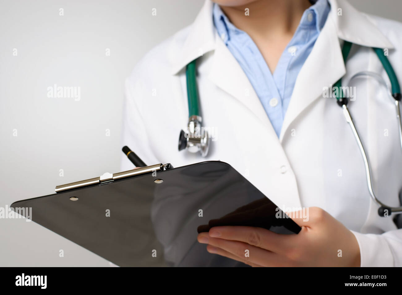Doctor taking notes on clipboard Stock Photo - Alamy