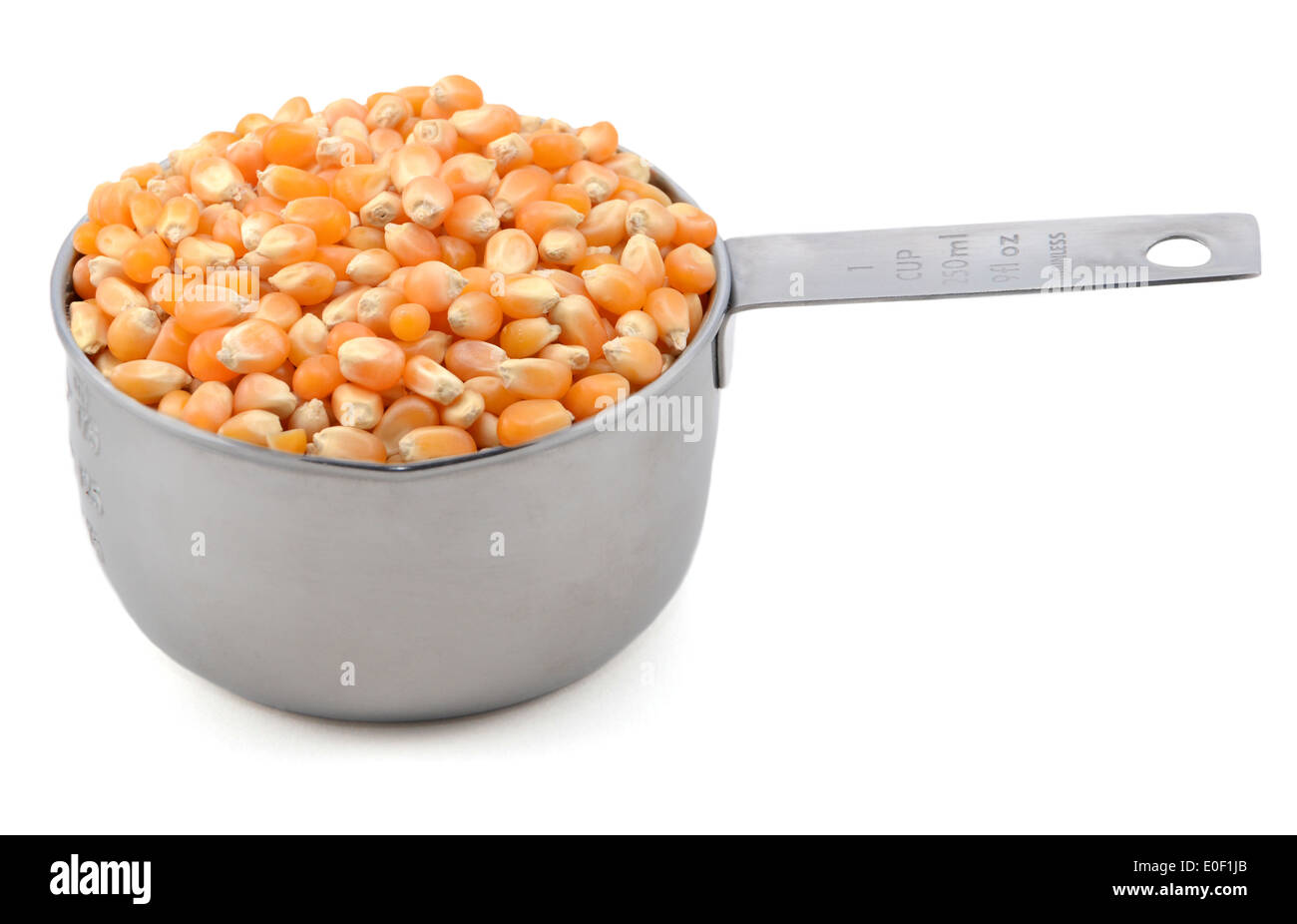 Popcorn maize in an American cup measure, isolated on a white ...