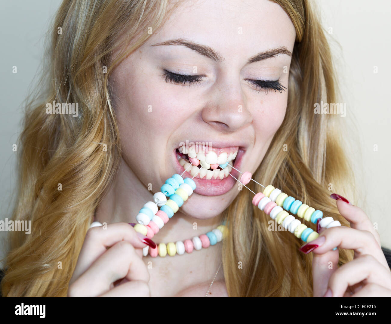 Teenage girl eating candy Stock Photo - Alamy