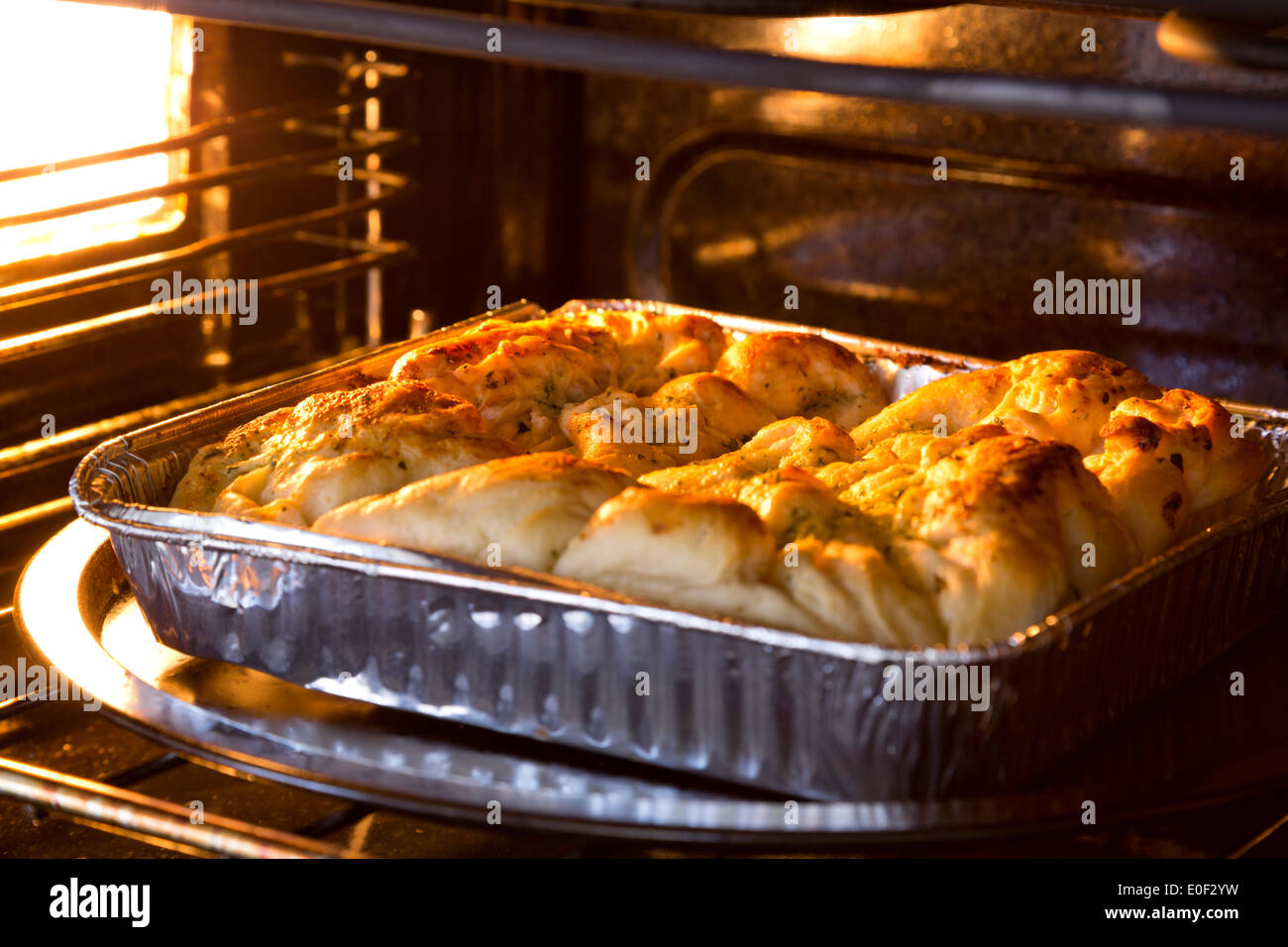 Garlic bread baking in oven Stock Photo - Alamy