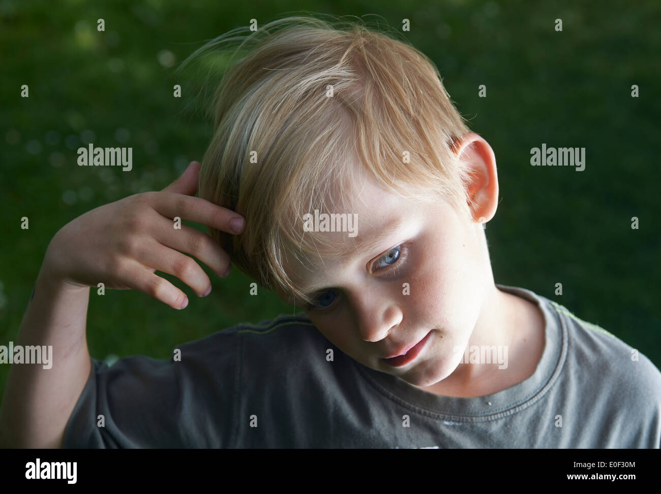 Young child blond Boy Thinking outside, portrait Stock Photo - Alamy