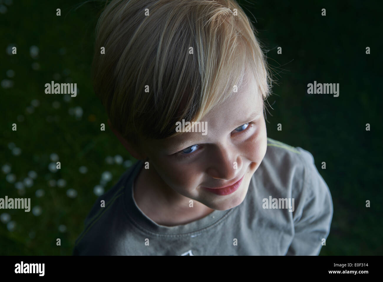 Silly young child blond boy gruesomely grimacing for camera Stock Photo ...