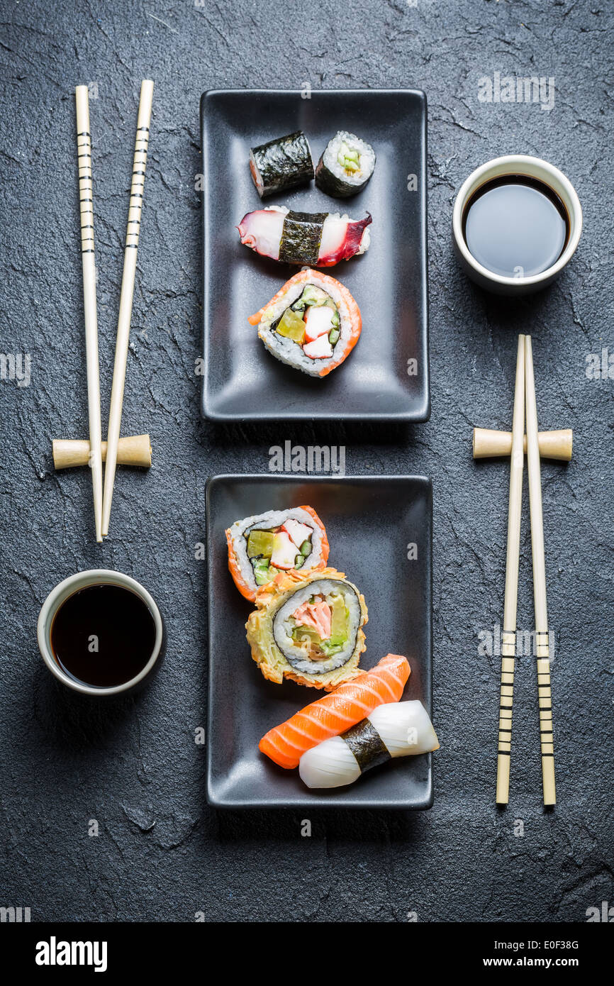 Sushi for two served in a black ceramic Stock Photo - Alamy