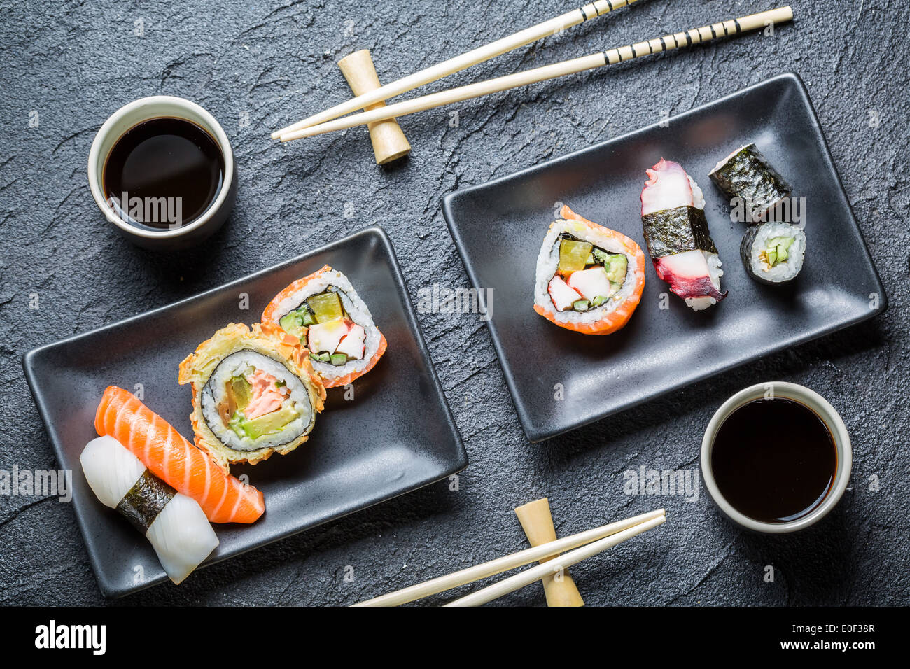 Sushi for two served in a black ceramic Stock Photo - Alamy