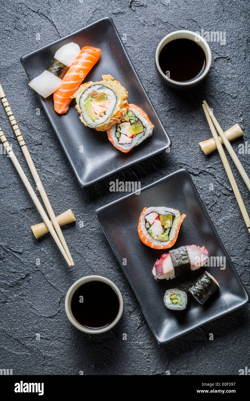 Sushi for two served on black stone Stock Photo - Alamy