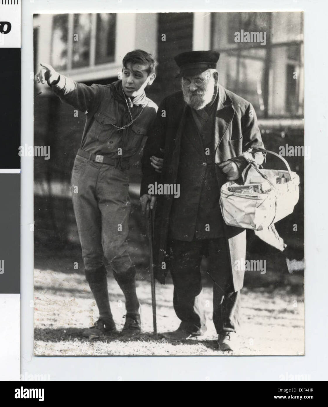 A photograph of a Boy Scout assisting an elderly man with directions ...