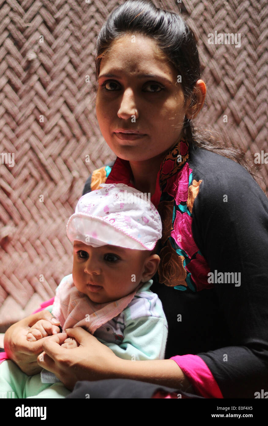 LAHORE, PAKISTAN, MAY 11: Pakistani mother is playing and expressing ...