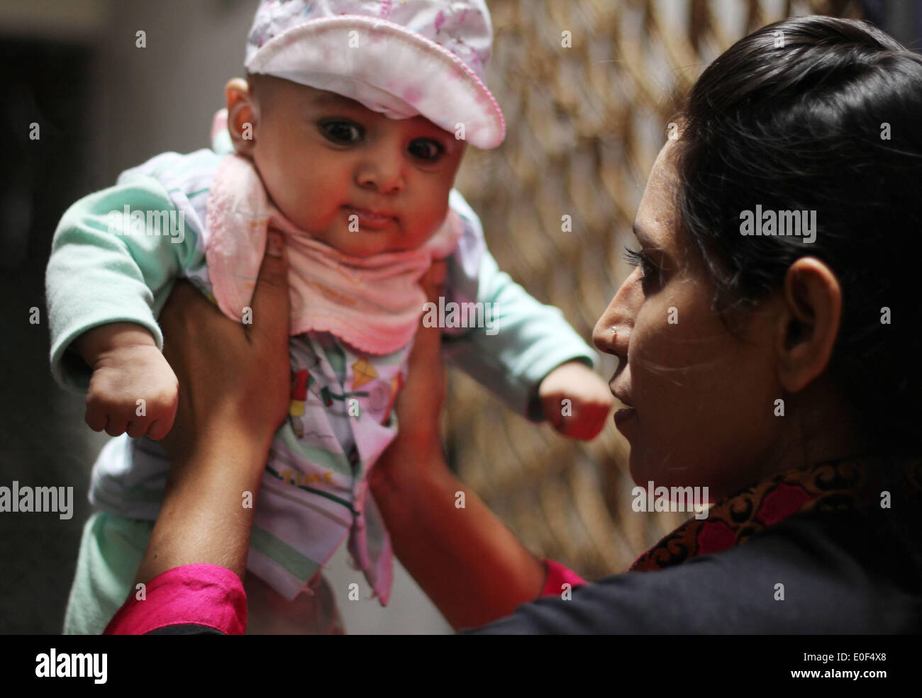LAHORE, PAKISTAN, MAY 11: Pakistani mother is playing and expressing ...