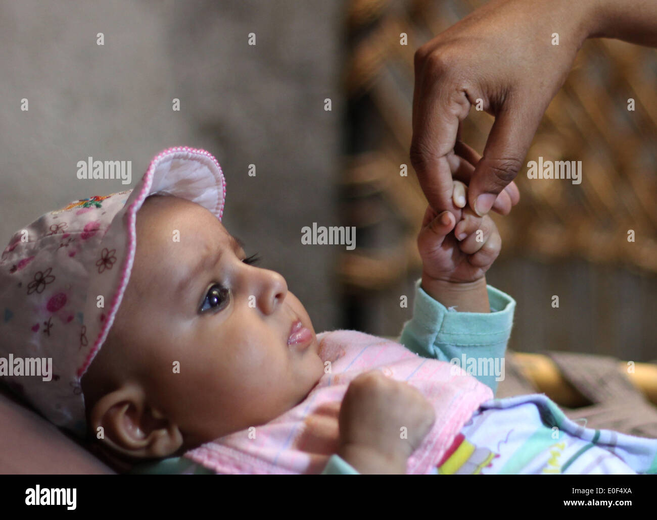 LAHORE, PAKISTAN, MAY 11: Pakistani mother is playing and expressing ...