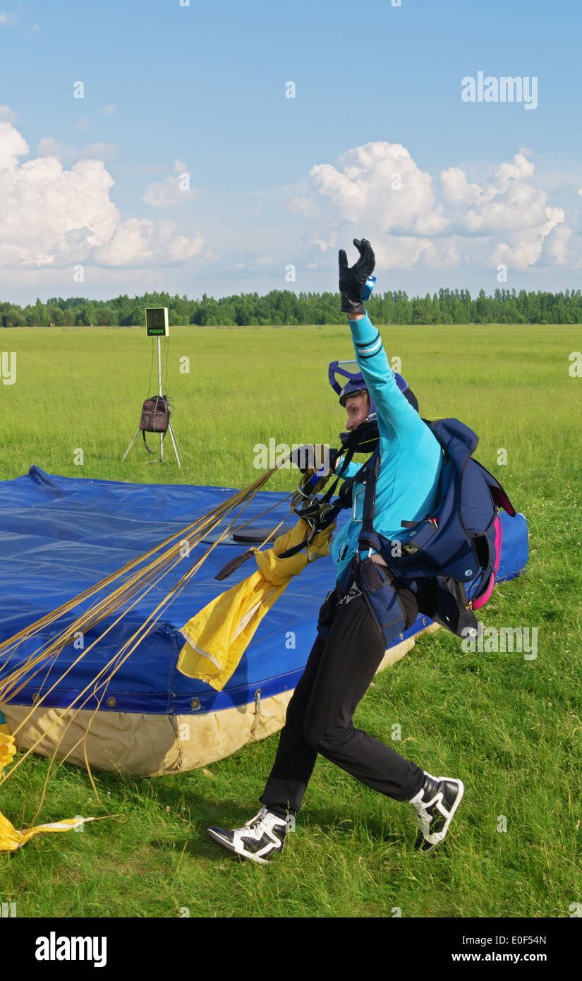 One day with parachutist in airfield. The girl skydiver after landing ...