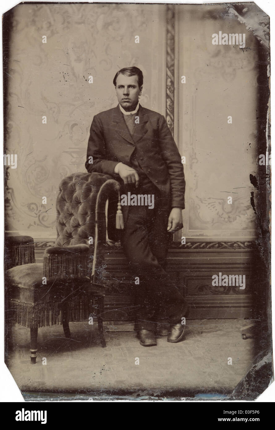 Man standing by chair, ca. 1856-1900 Stock Photo - Alamy