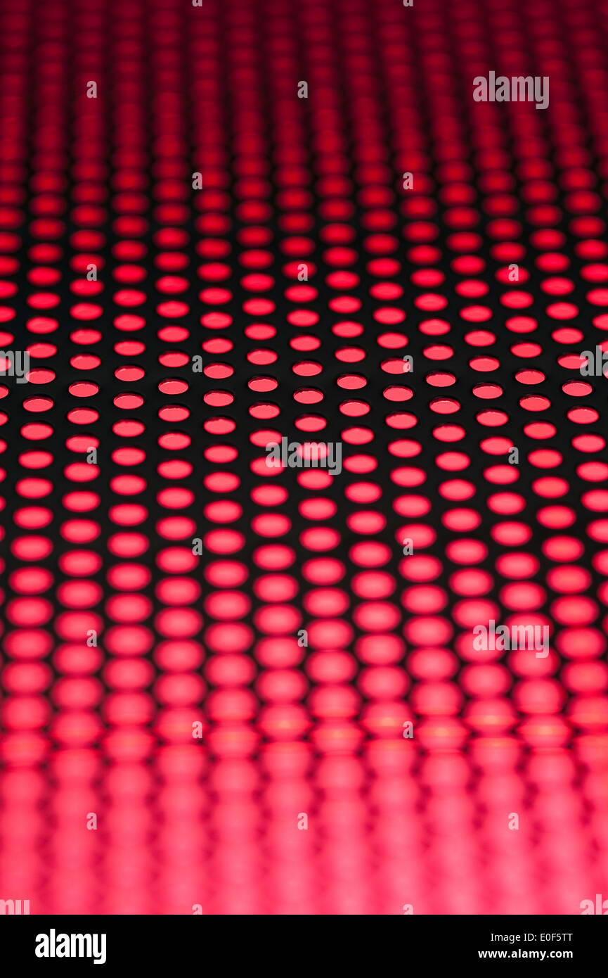 Metal grid with hole patterns and colored lights Stock Photo - Alamy