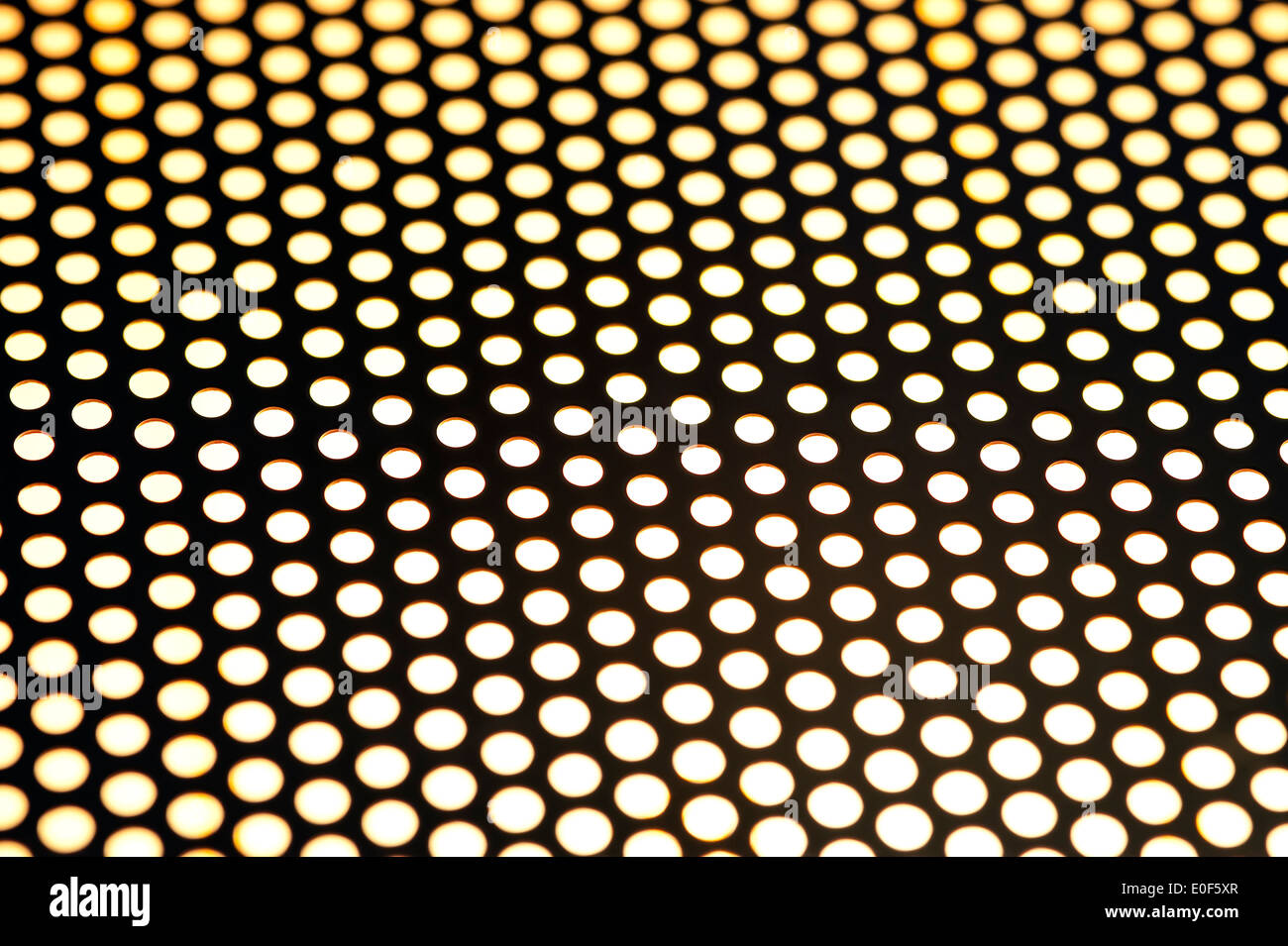 Metal grid with hole patterns and colored lights Stock Photo - Alamy