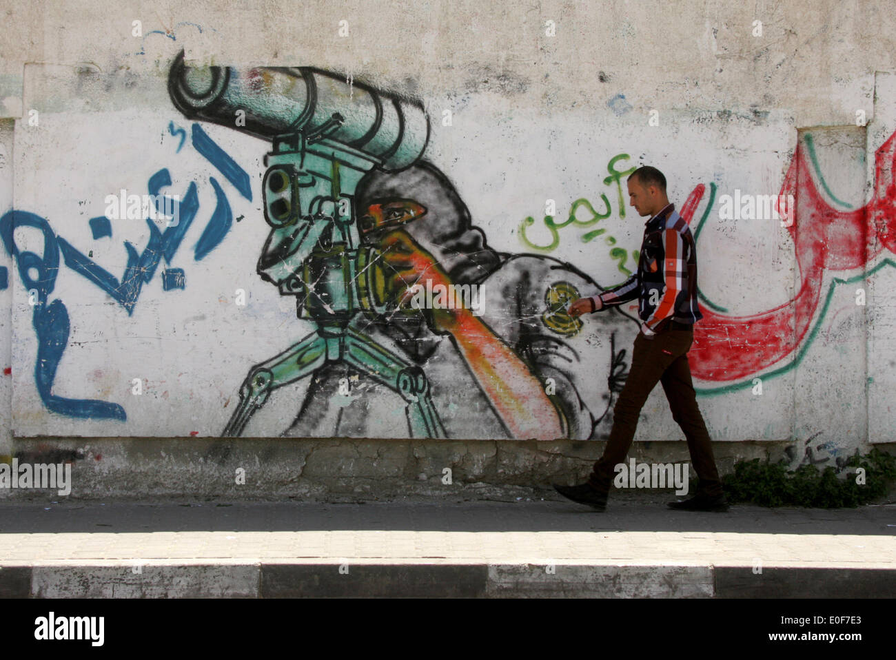 RAFAH, PALESTINE - MAY 11: A Palestinians man walks next to a wall ...
