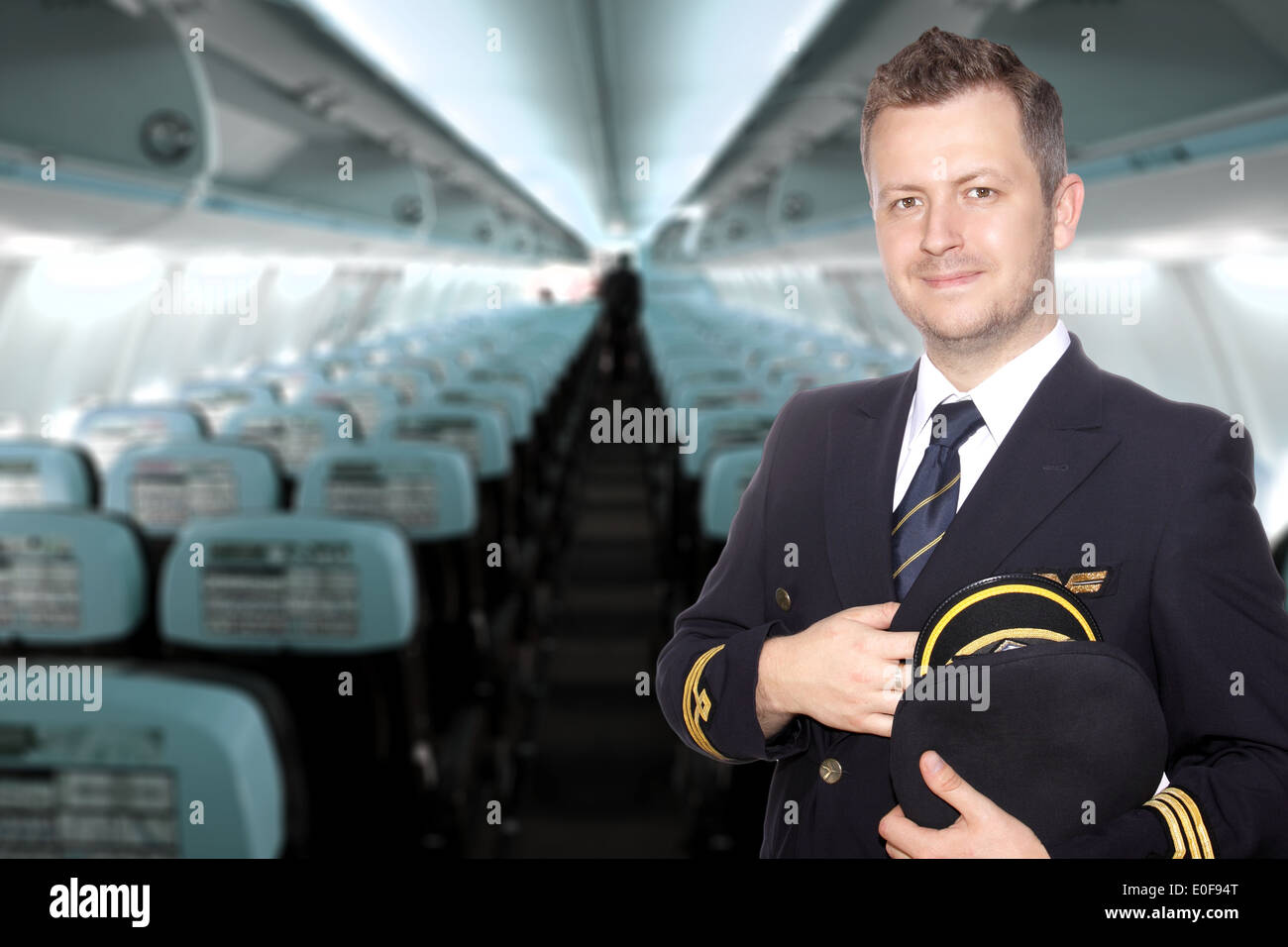 Smiling pilot in the cabin of the aircraft Stock Photo - Alamy