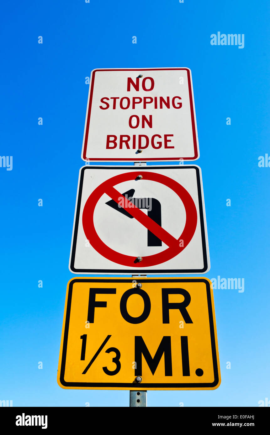 No Stopping on Bridge No Left Turn sign against a blue sky Stock Photo ...