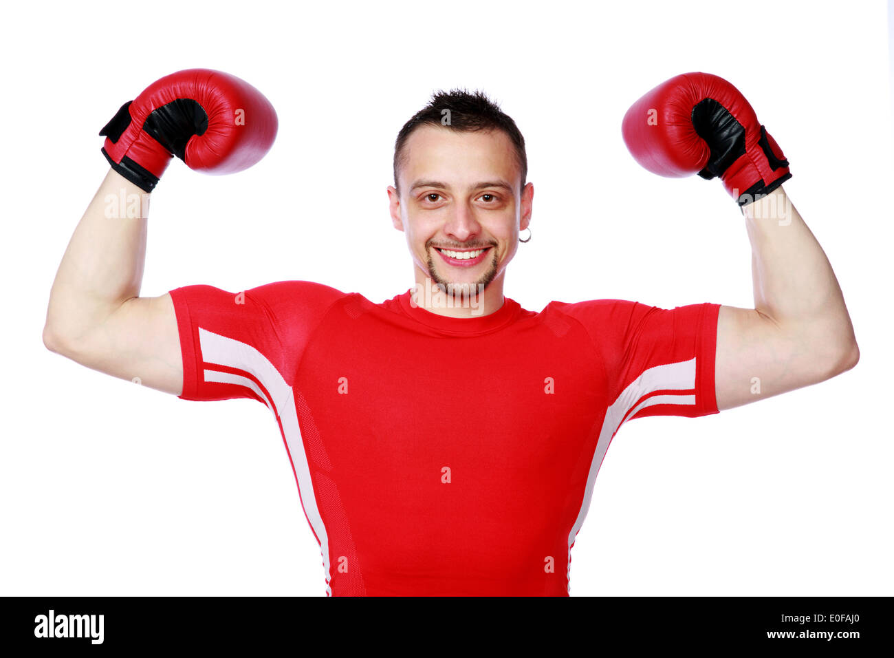 Cheerful boxer man winner raising arms over white background Stock ...