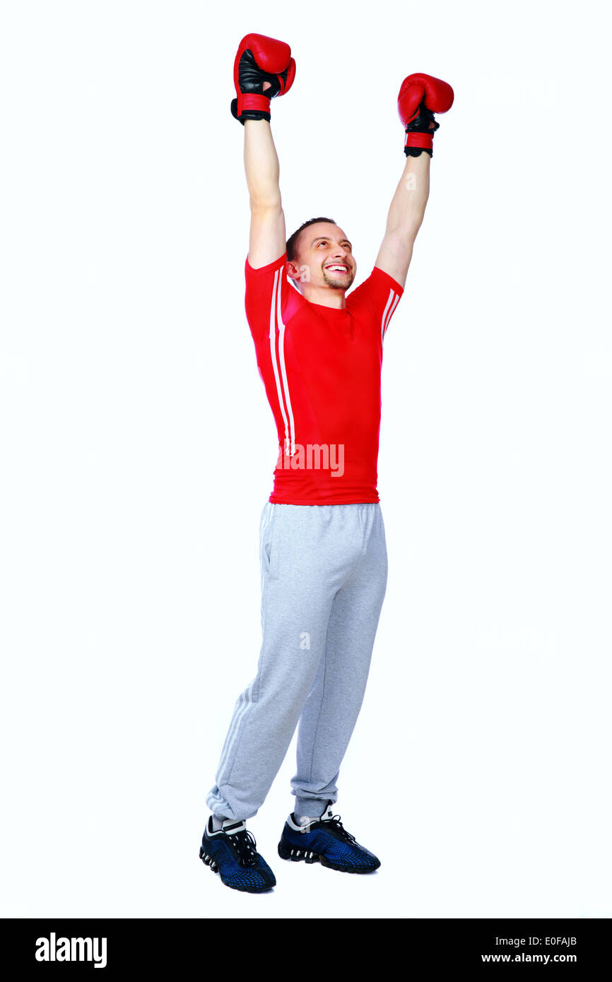 Full length portrait of a happy boxer man winner raising arms over ...