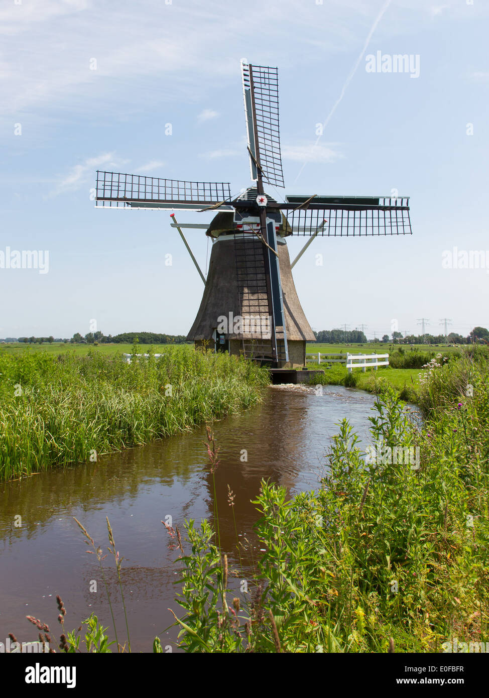 Traditional old dutch windmill in a summer landscape Stock Photo - Alamy
