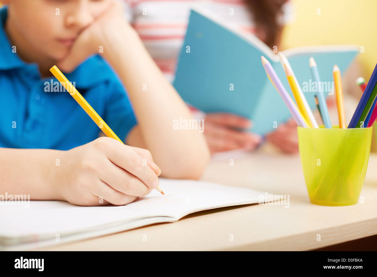 Portrait of smart lad drawing with pencils at lesson Stock Photo - Alamy
