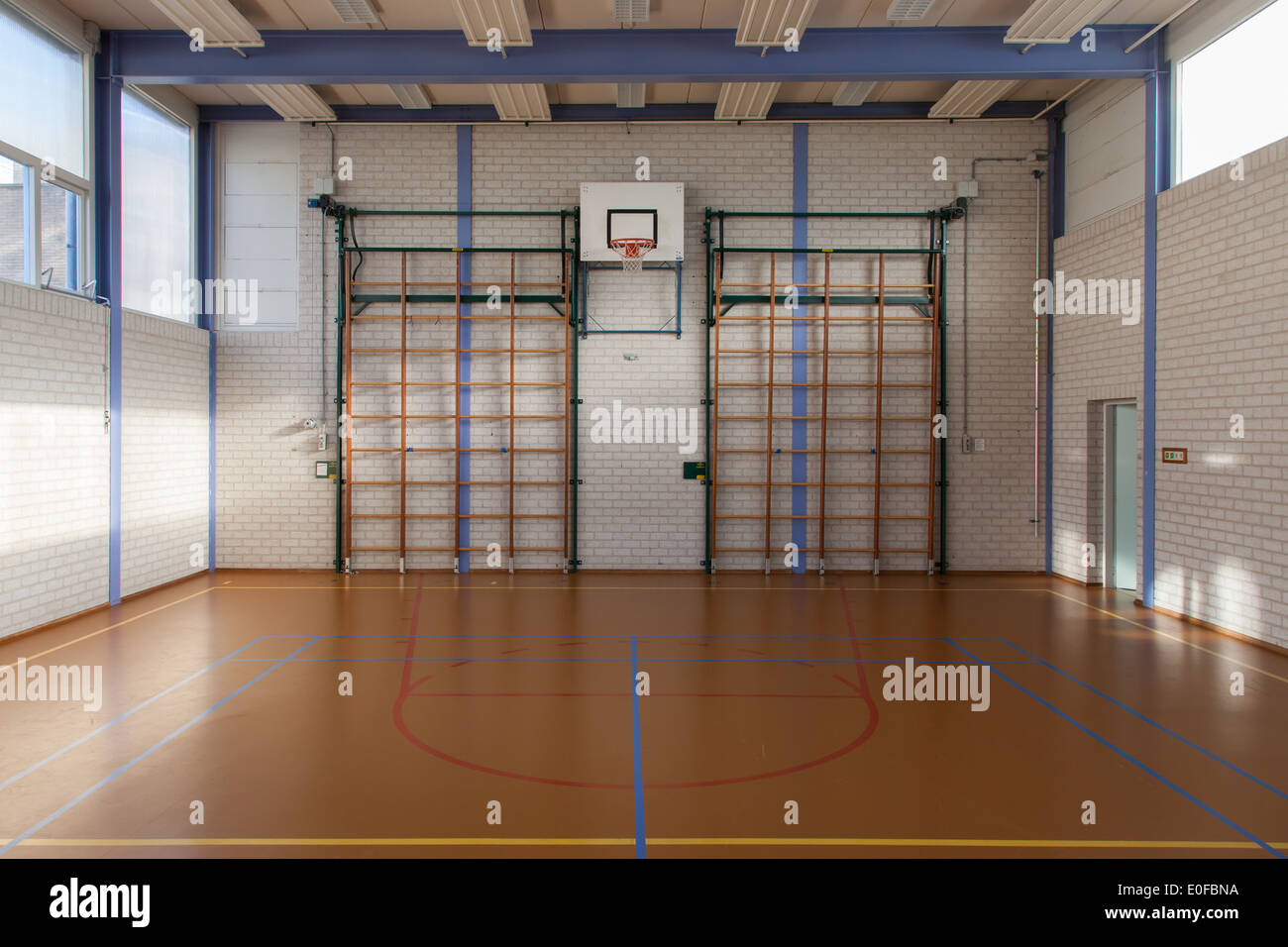 Interior of a gym at school, jumping high at the basket Stock Photo - Alamy
