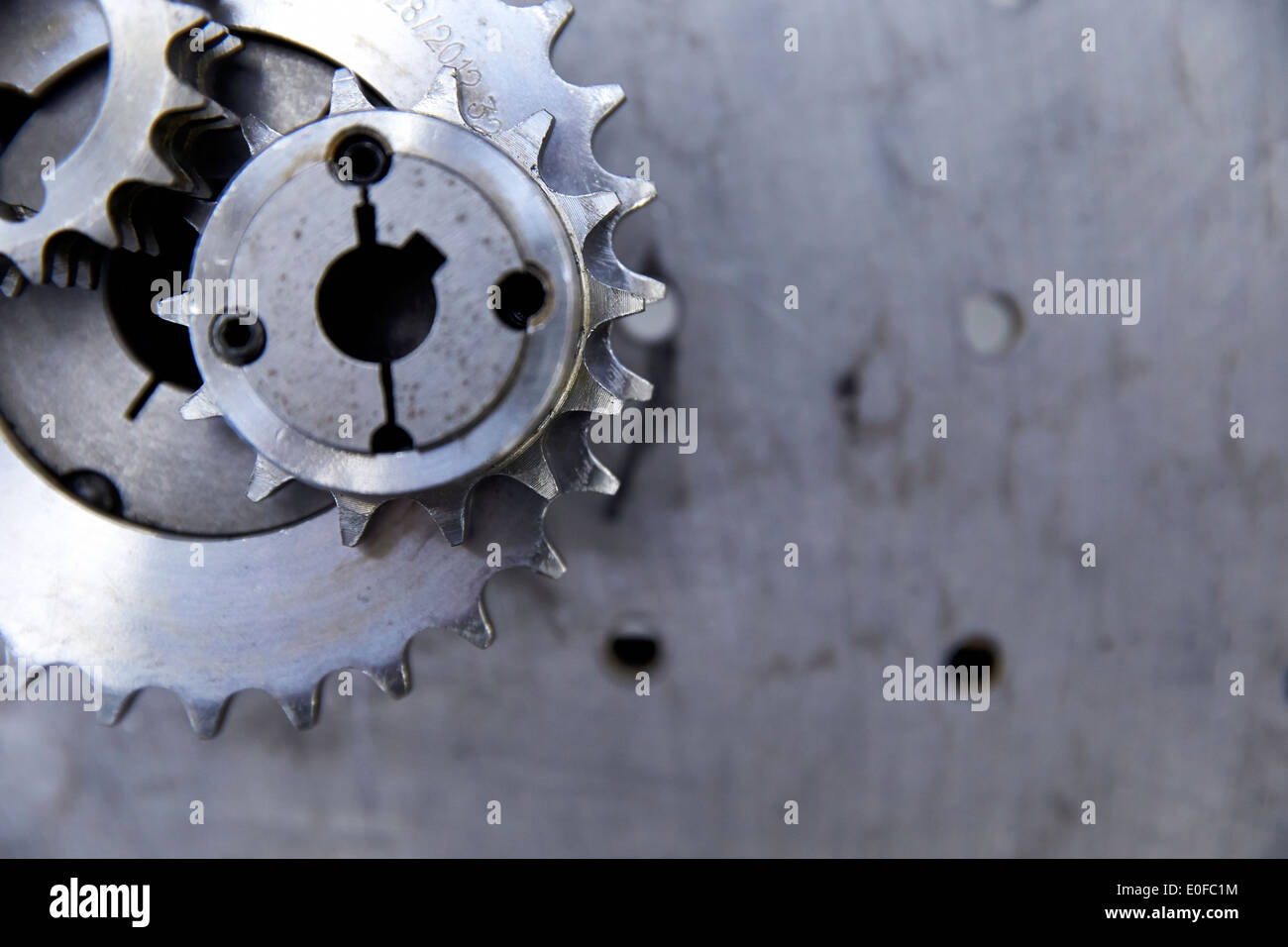 Cogs and gears on a metal work bench in a manufacturing factory Stock ...
