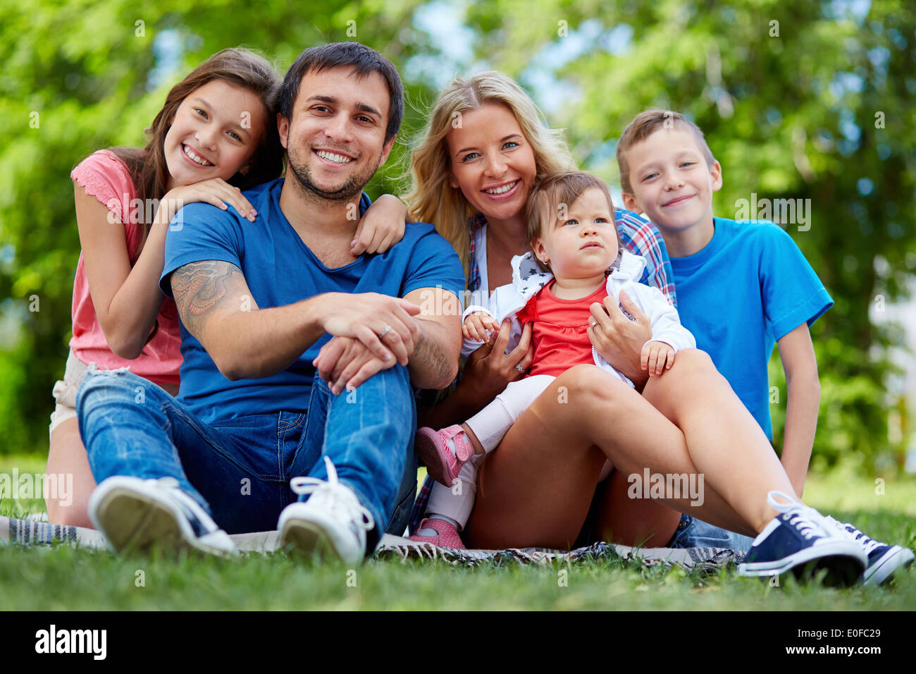 Photo of happy family looking at camera outdoors Stock Photo - Alamy