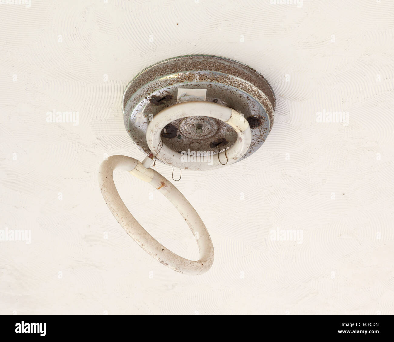 Rusted broken lamp hanging on a ceiling Stock Photo - Alamy