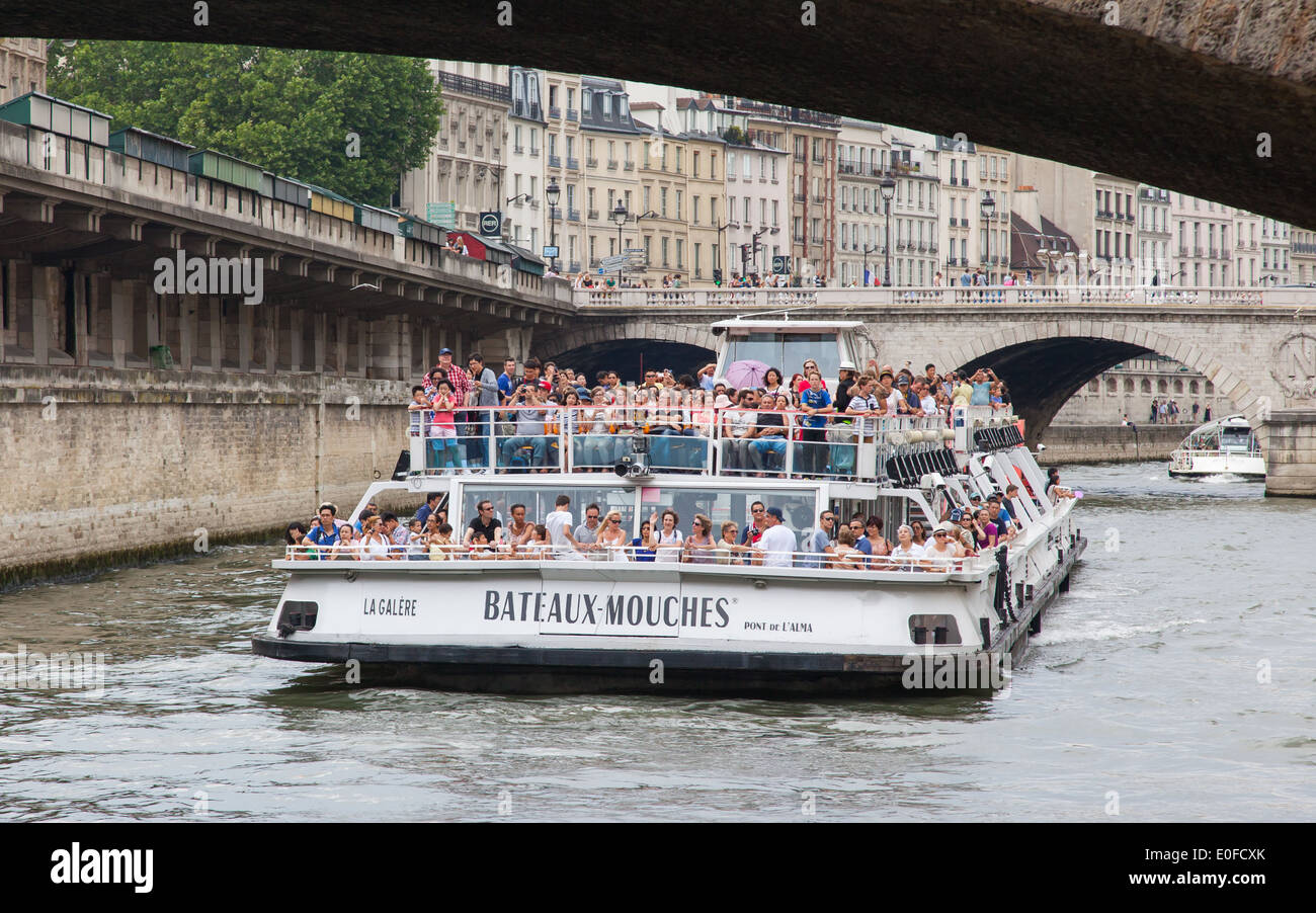 PARIS FRANCE - JULY 27: Tourists enjoy a boat trip on Seine river near ...