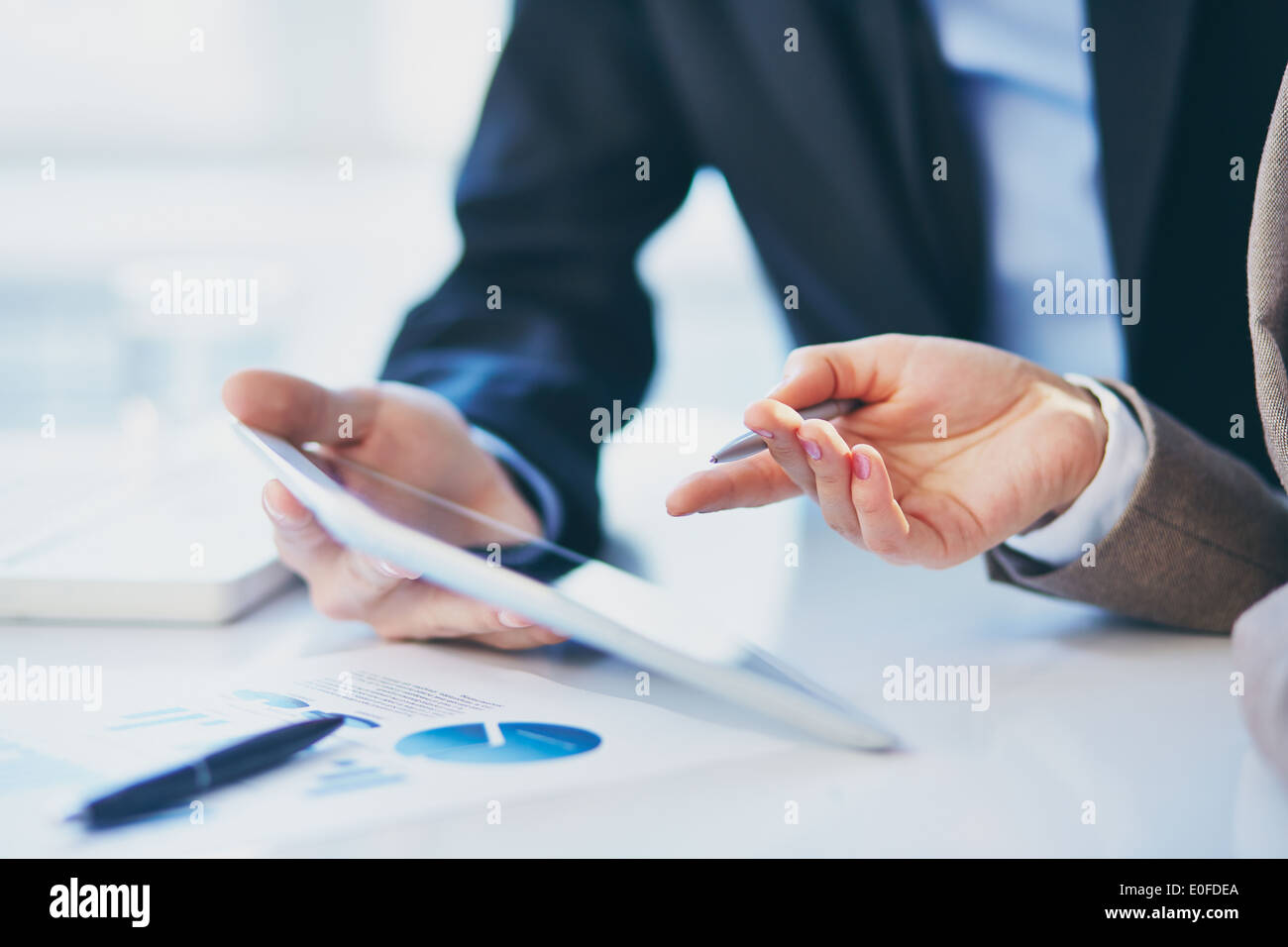 Female hand during explanation of report in touchpad Stock Photo - Alamy