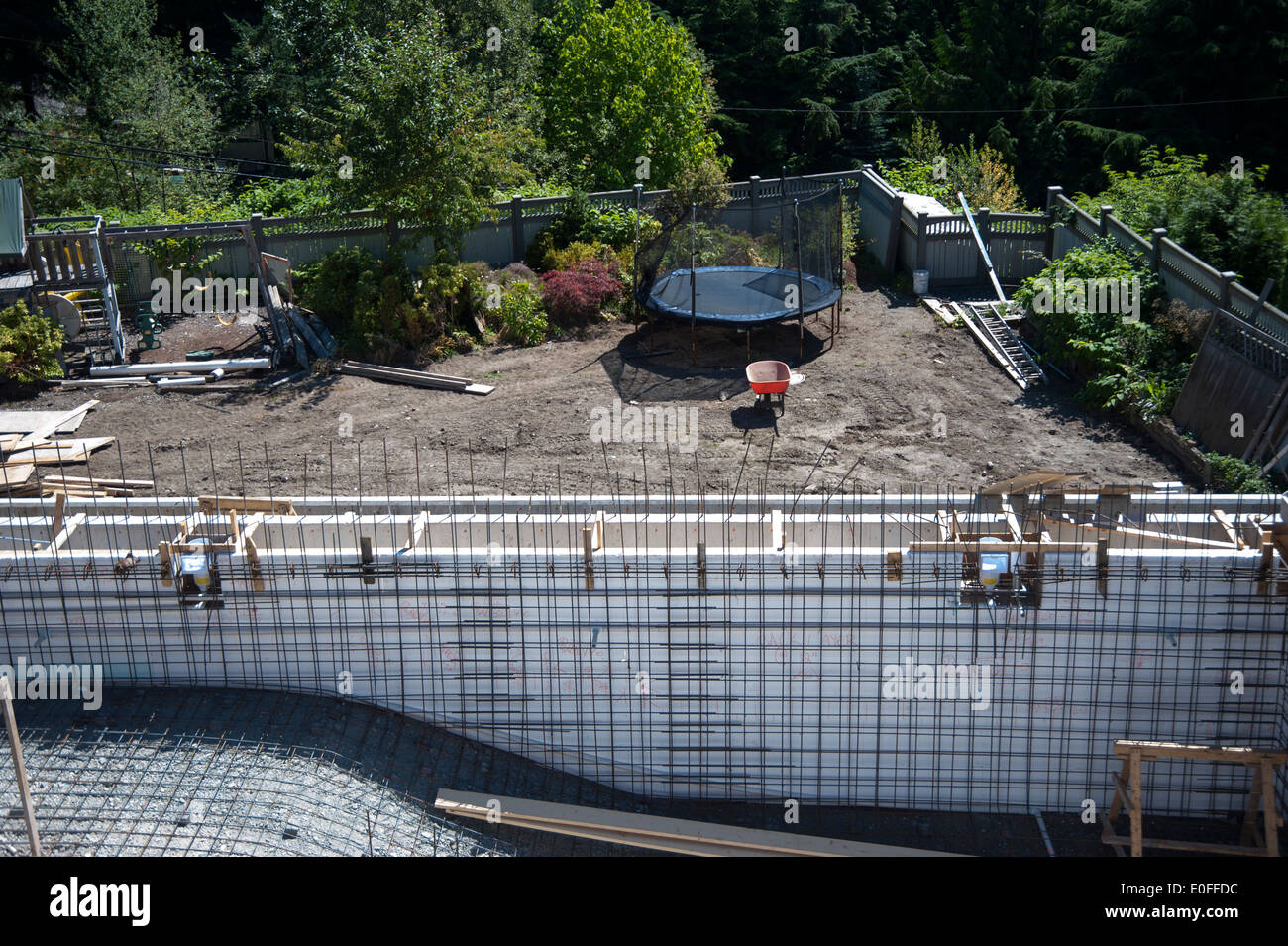 Backyard pool being built with rebar lining installed Stock Photo - Alamy