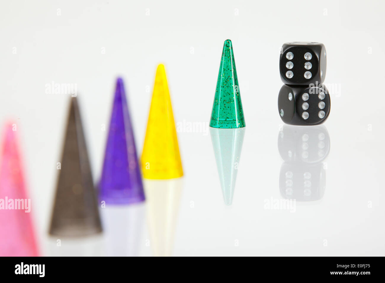 Different colored pawns isolated on a white background, selective focus ...