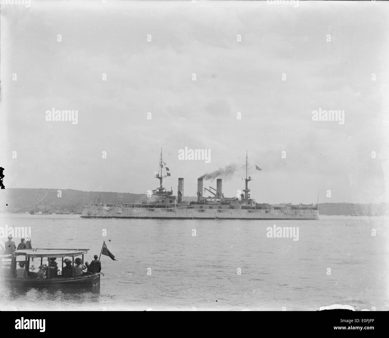This photograph shows spectators viewing a battleship as part of the ...