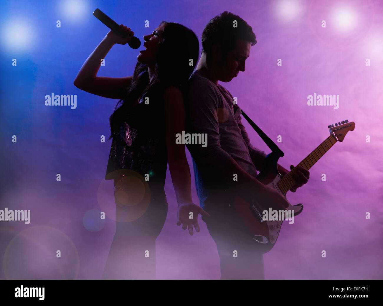 Silhouettes of singer and guitar player on stage Stock Photo - Alamy