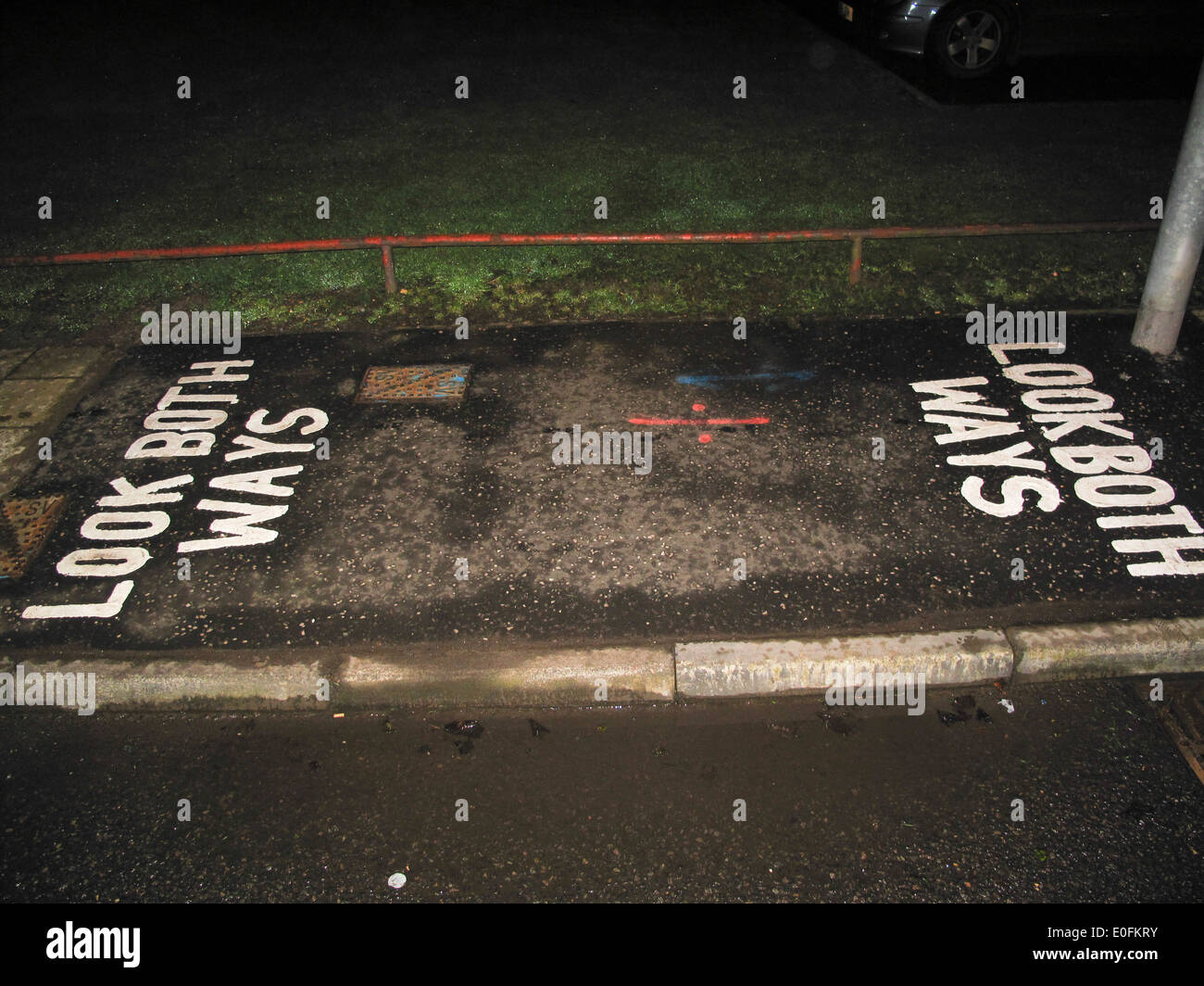 Look both ways lettering on pavement Stock Photo - Alamy