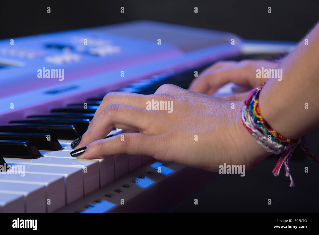 Hands of female musician playing keyboard Stock Photo - Alamy