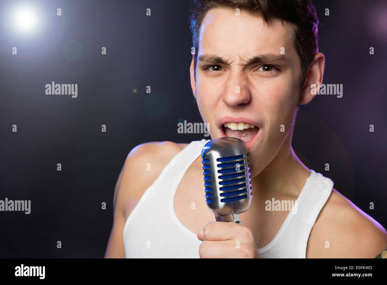 Male singer on stage Stock Photo - Alamy