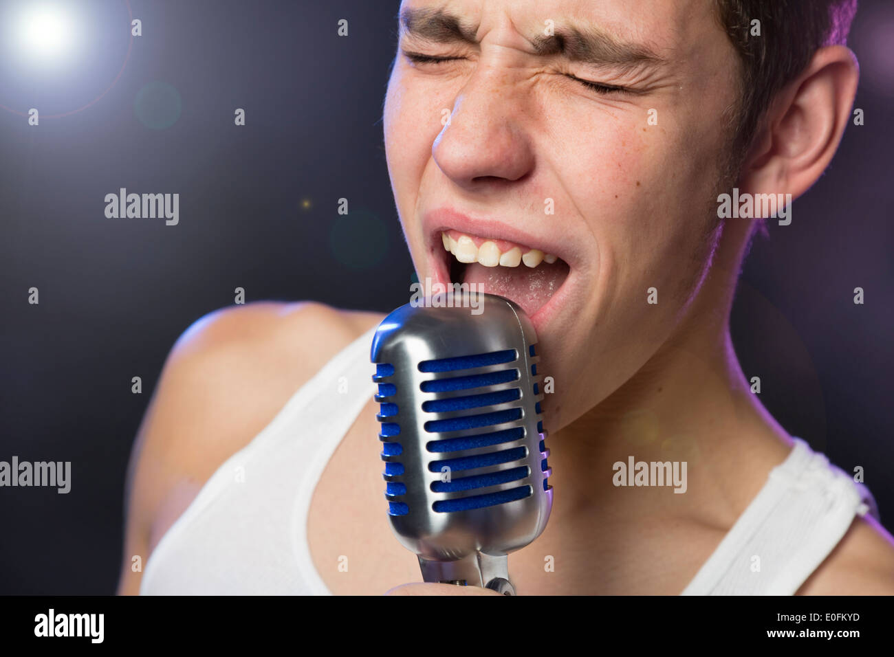 Male singer on stage Stock Photo - Alamy