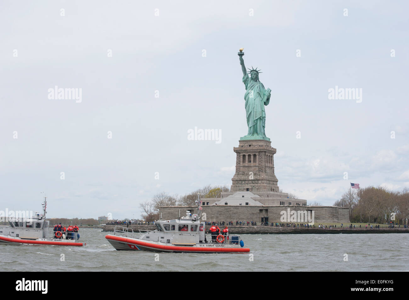 The U.S. Coast Guard stationed in front of the Statue of Liberty on a ...