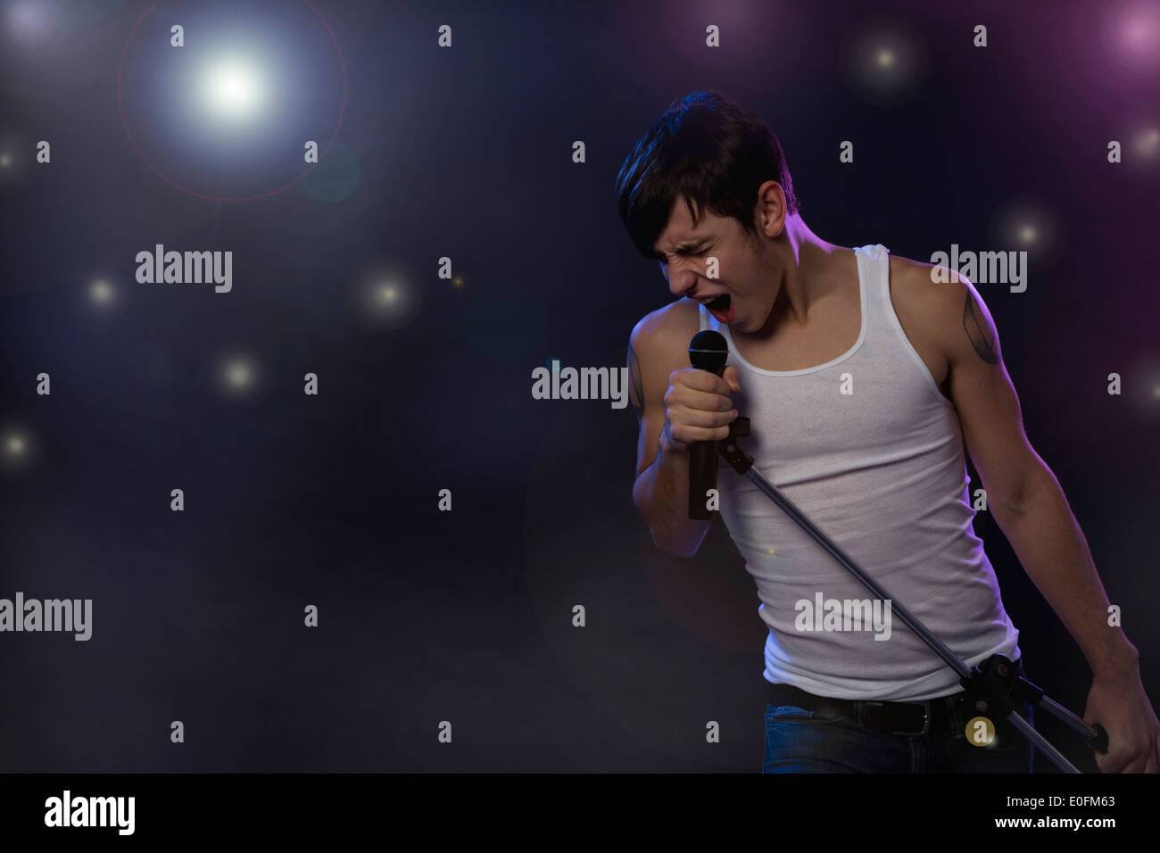 Male singer on stage Stock Photo - Alamy