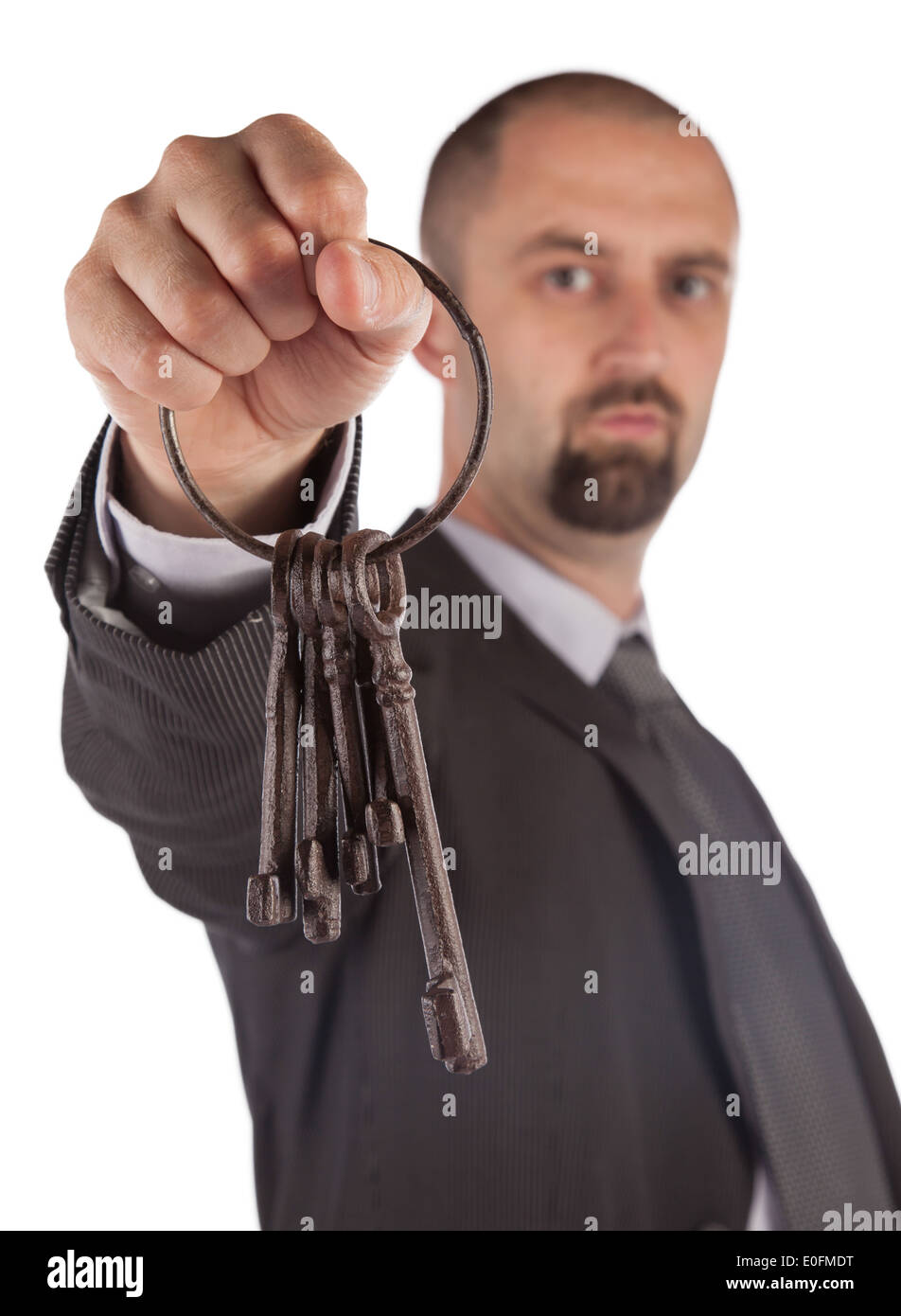 Man in suit giving old keys to a house, isolated on white Stock Photo ...